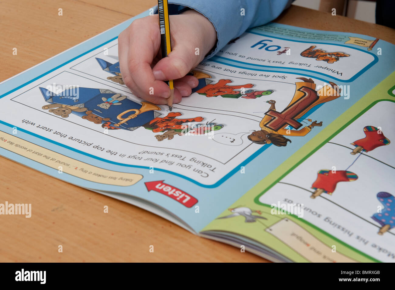 A young schoolgirl completes her homework assignment in writing ...