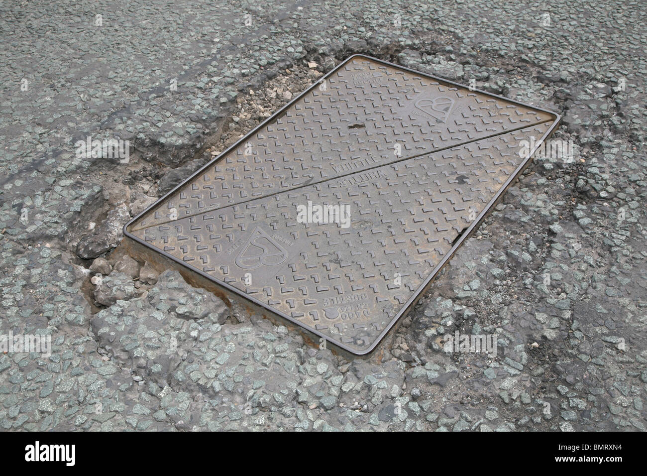 pothole damage around a manhole Stock Photo - Alamy
