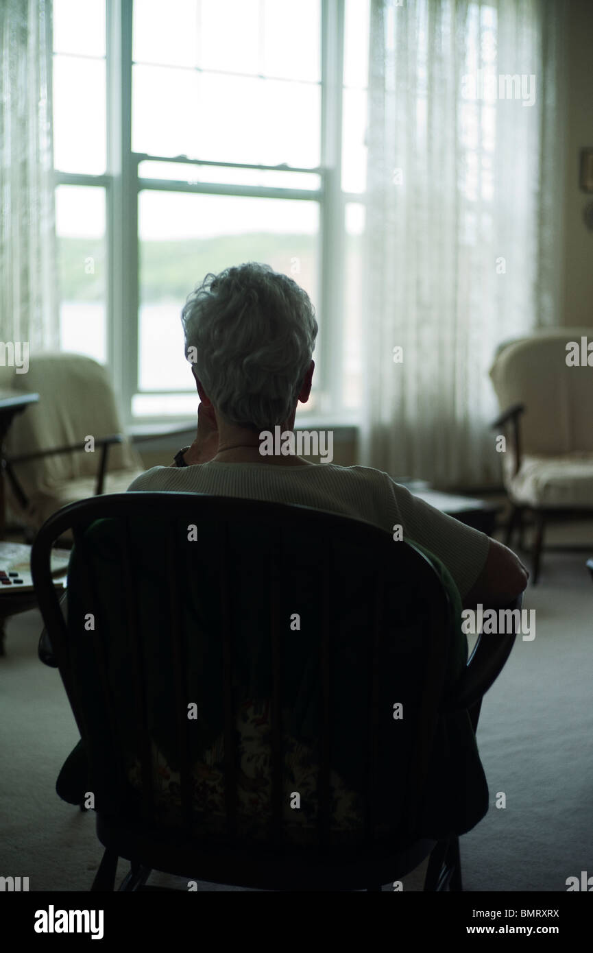 Old woman from behind as she sits looking out window Stock Photo - Alamy