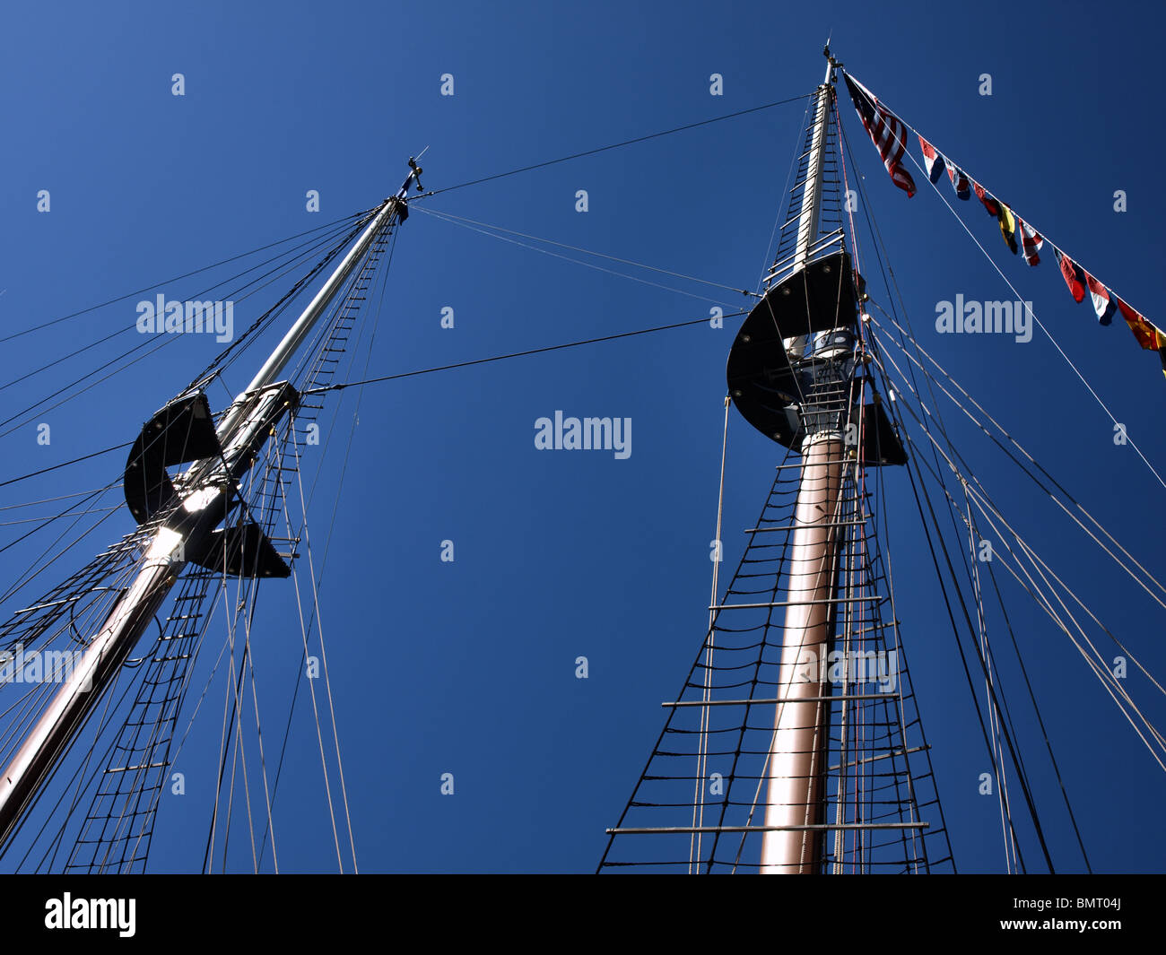 tall ship three masted masts ratings ladders flags blue sky sails Stock ...
