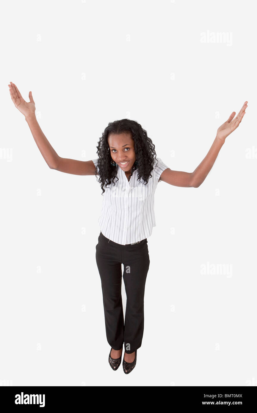 Young woman standing and looking up with hands outstretched Stock Photo ...