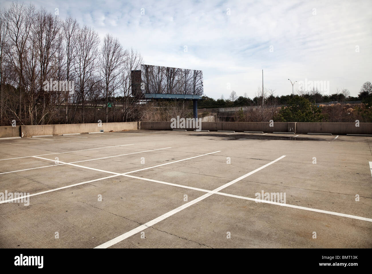 Empty parking lot by trees and billboard with picture of trees Stock ...