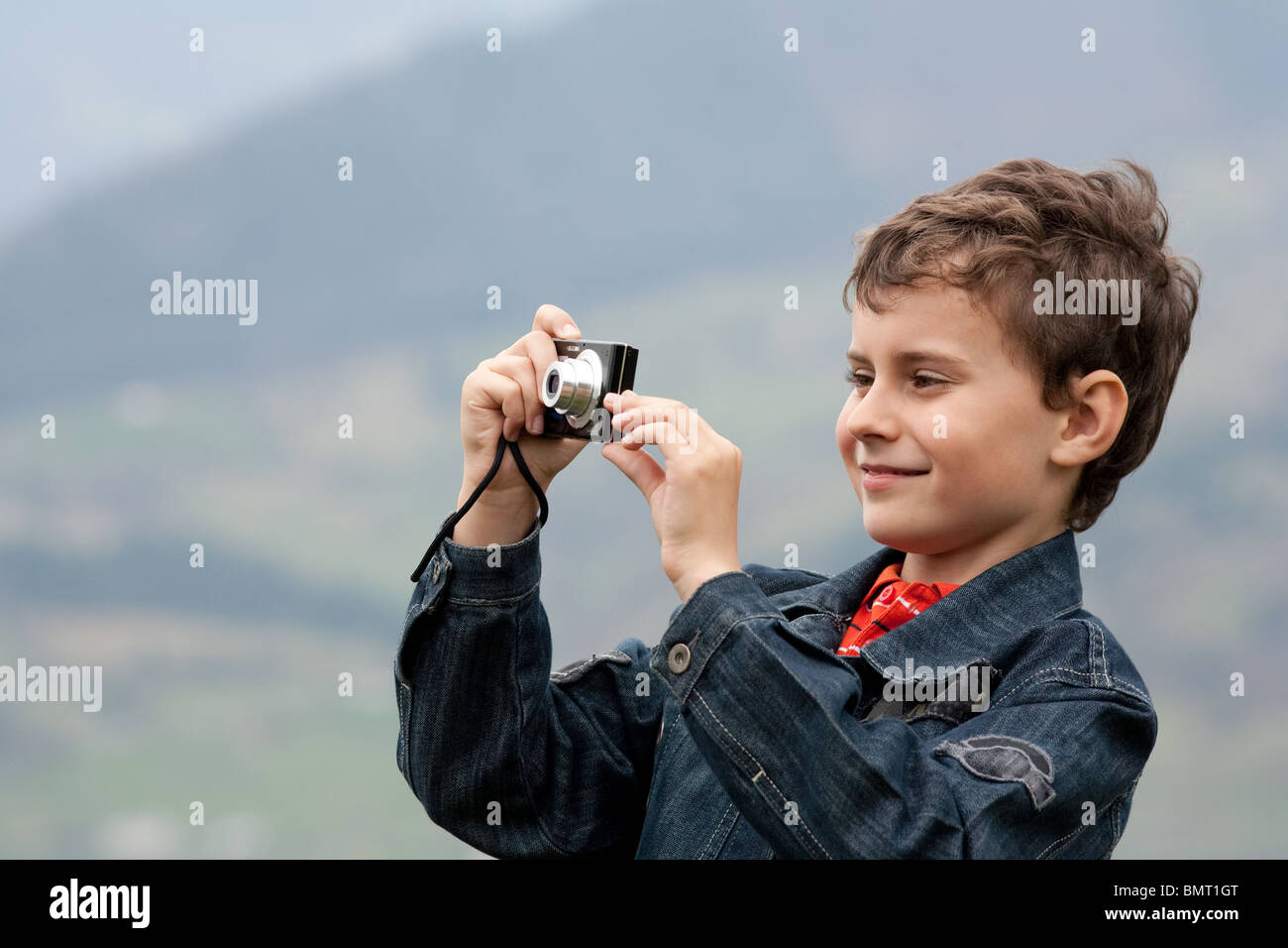 Cute little caucasian boy taking snapshots outdoor Stock Photo - Alamy