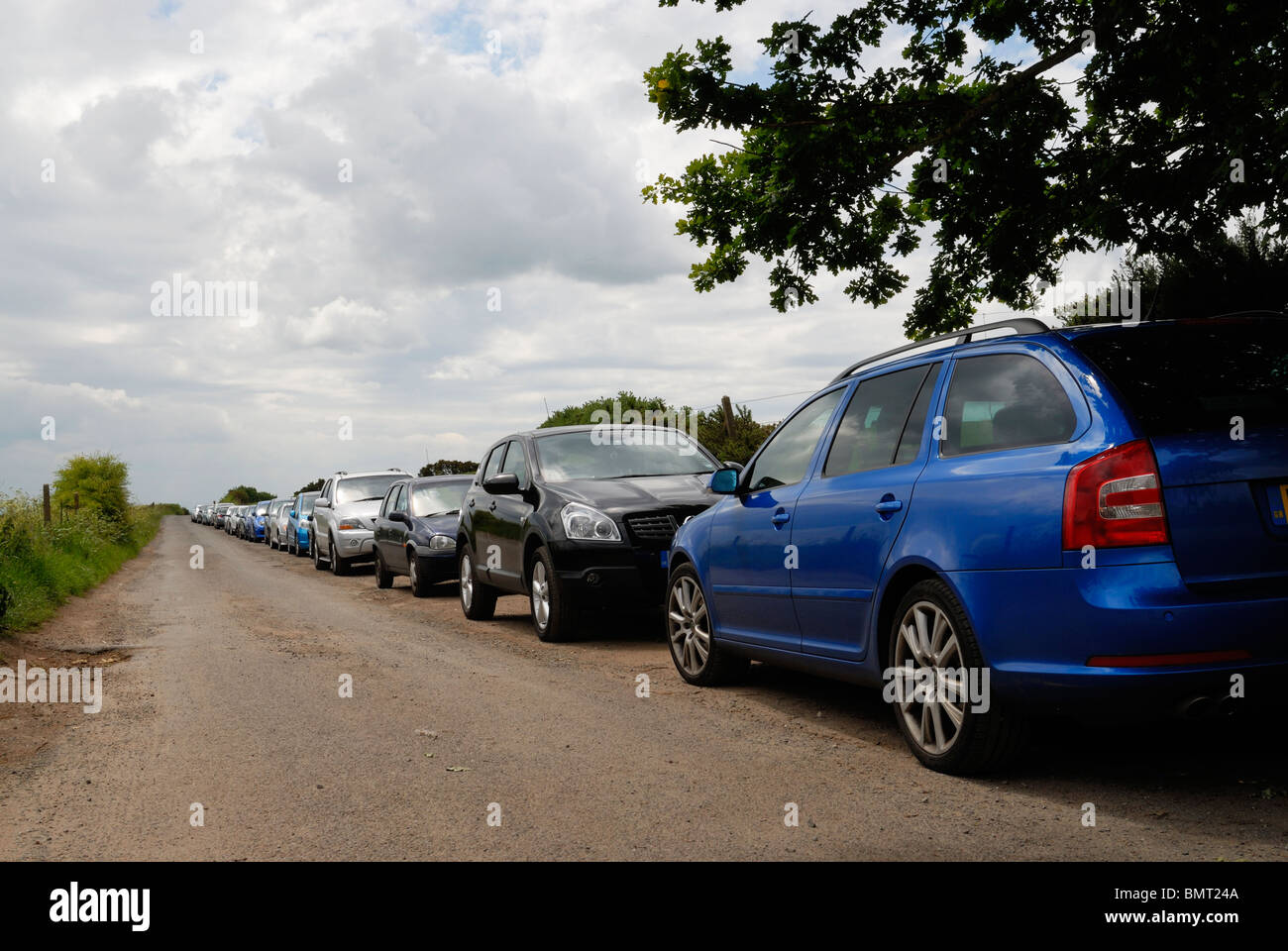 Cars parked in narrow lane in a popular walking area of Cheshire on the ...