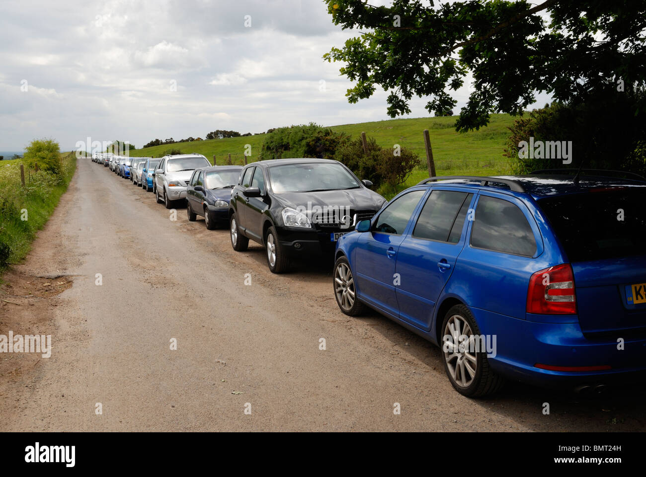 Cars parked in narrow lane in a popular walking area of Cheshire on the ...