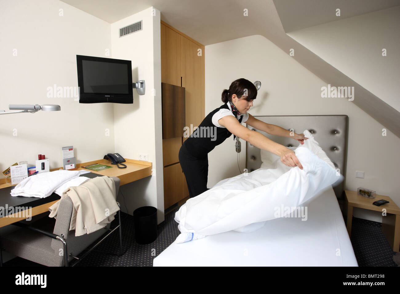 Hotel, room service, house keeping at work in a hotel room. Cleaning up ...
