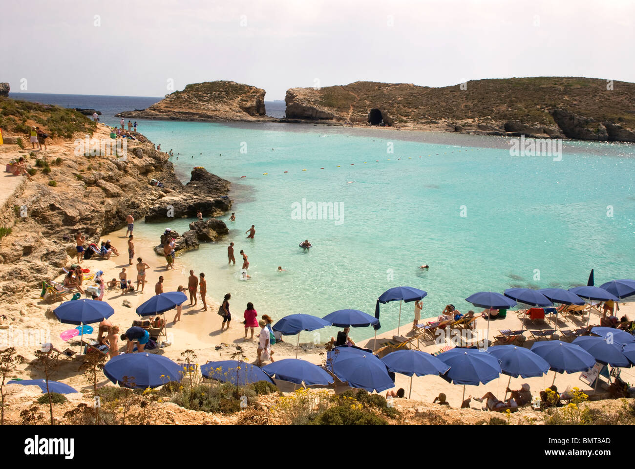 Tourists enjoying the clear waters of the Blue Lagoon, Comino, Malta ...