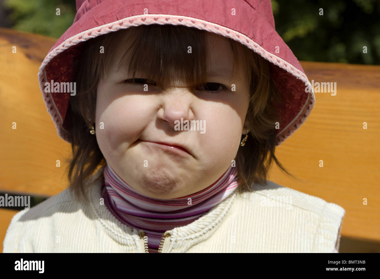 grimace of little girl Stock Photo - Alamy