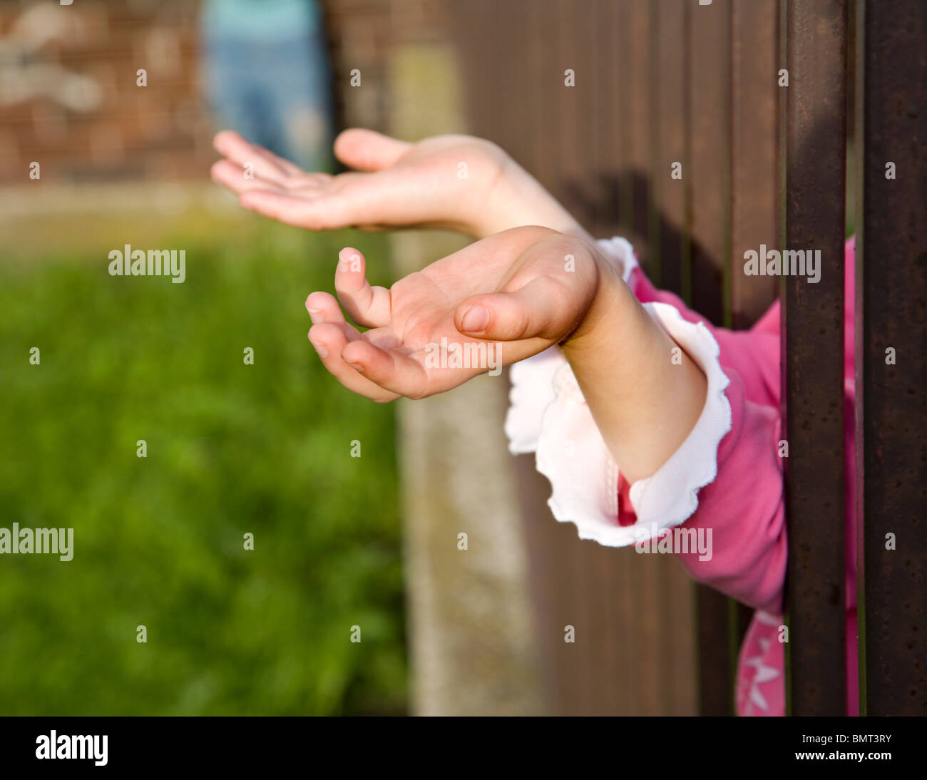hands of little girl and grate Stock Photo - Alamy