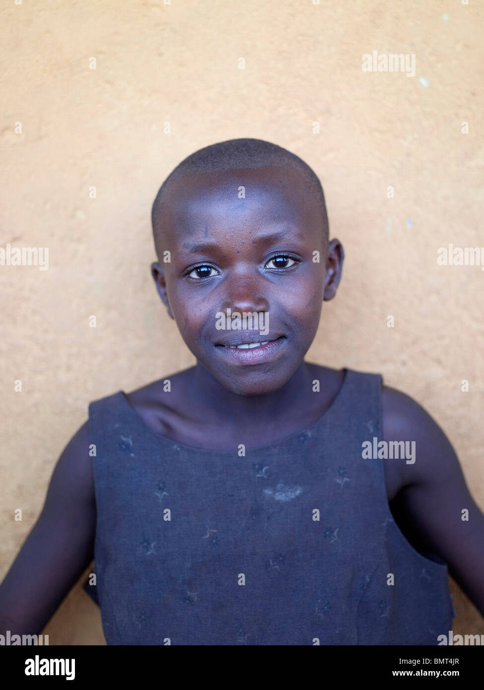 Small African boy against a yellow wall in Rwanda, post genocide Stock ...