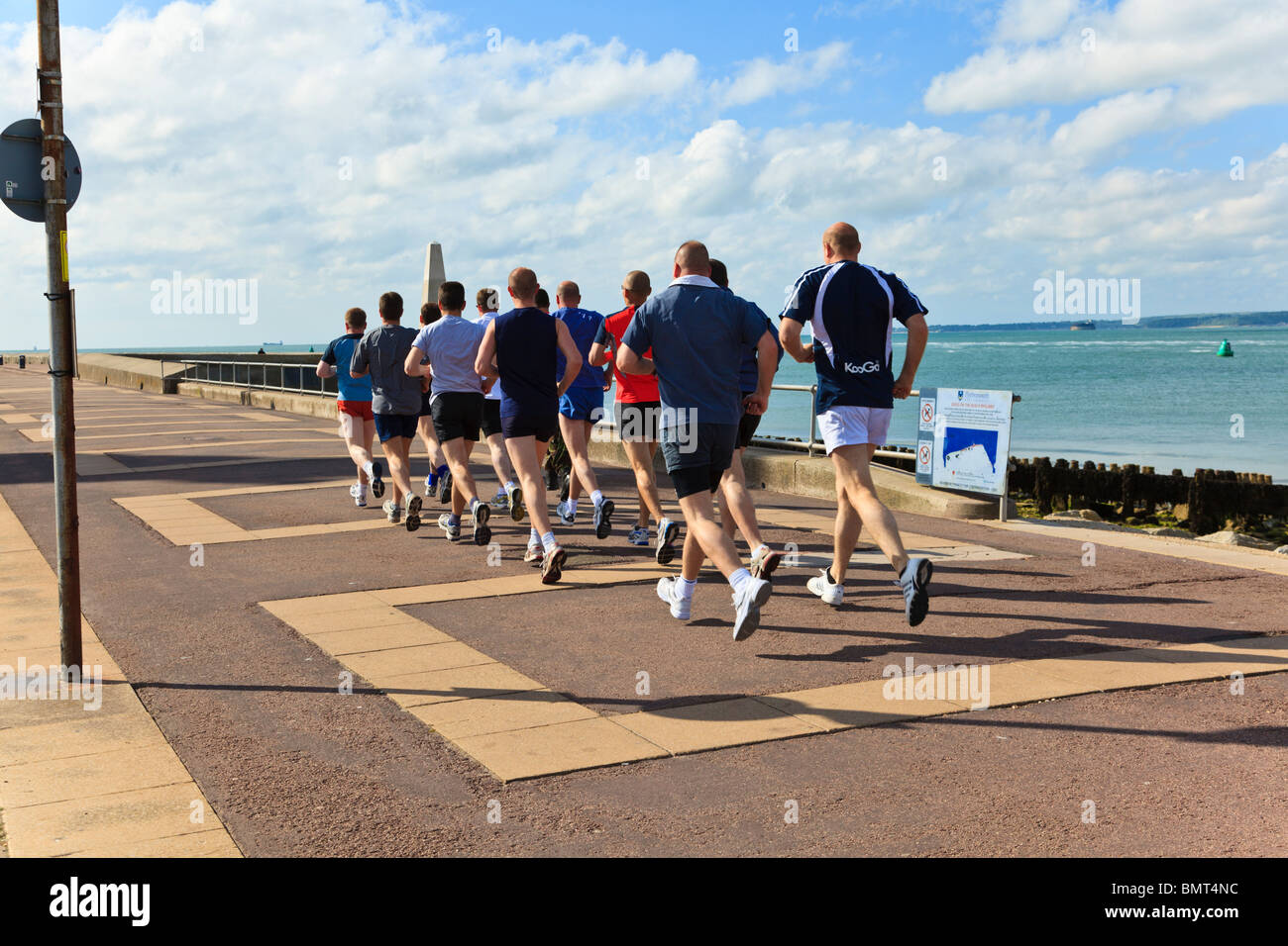 Group of sailors run "in step" on Southsea promenade, led by a Physical ...