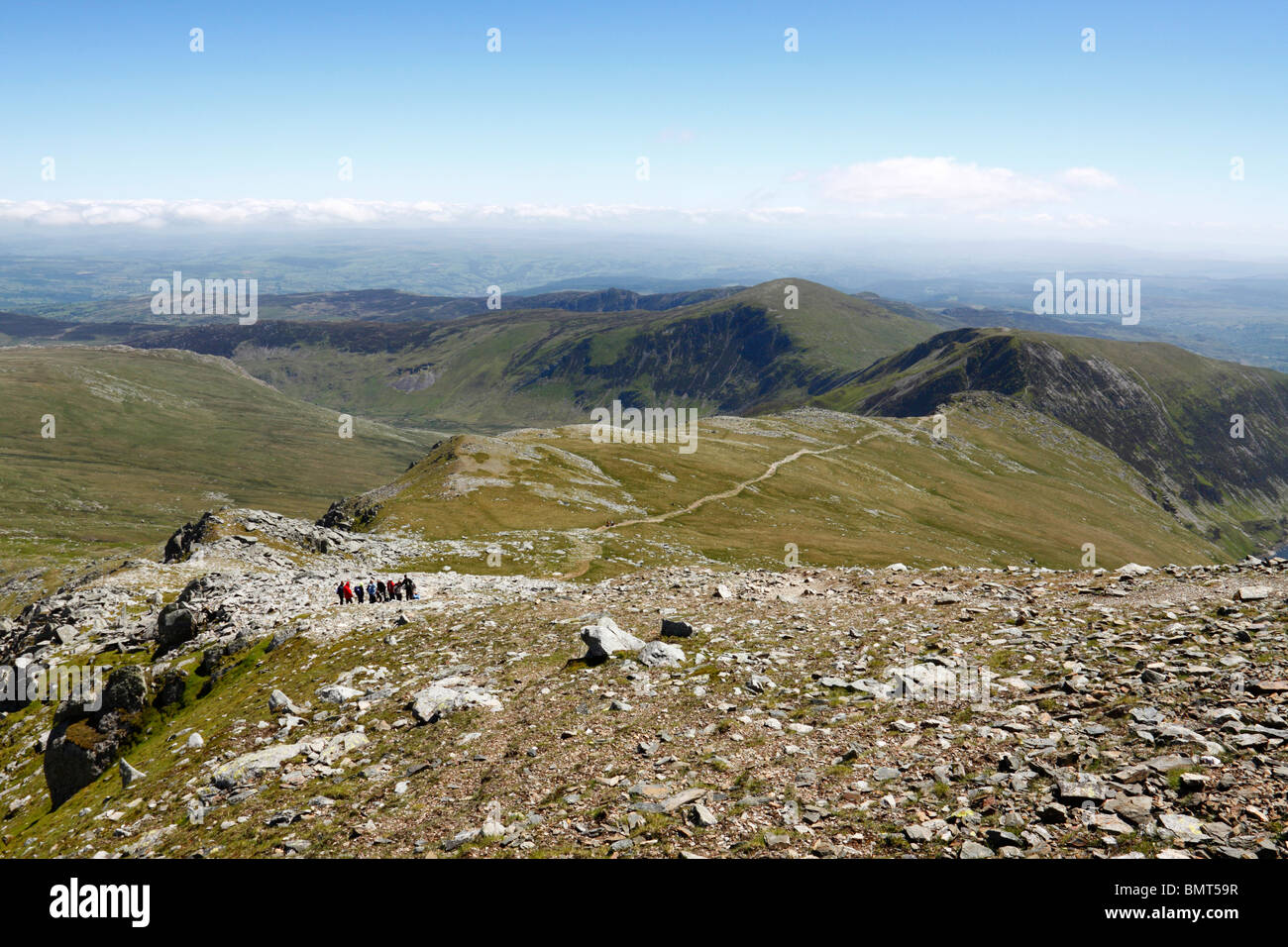 A group descend the east ridge of Carnedd Llewelyn in Snowdonia. Views ...