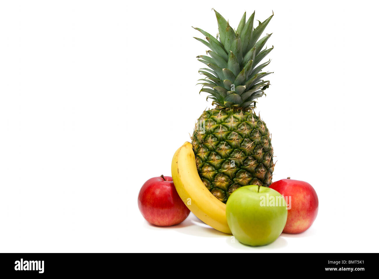 Ananas, banana and apples on white background Stock Photo - Alamy