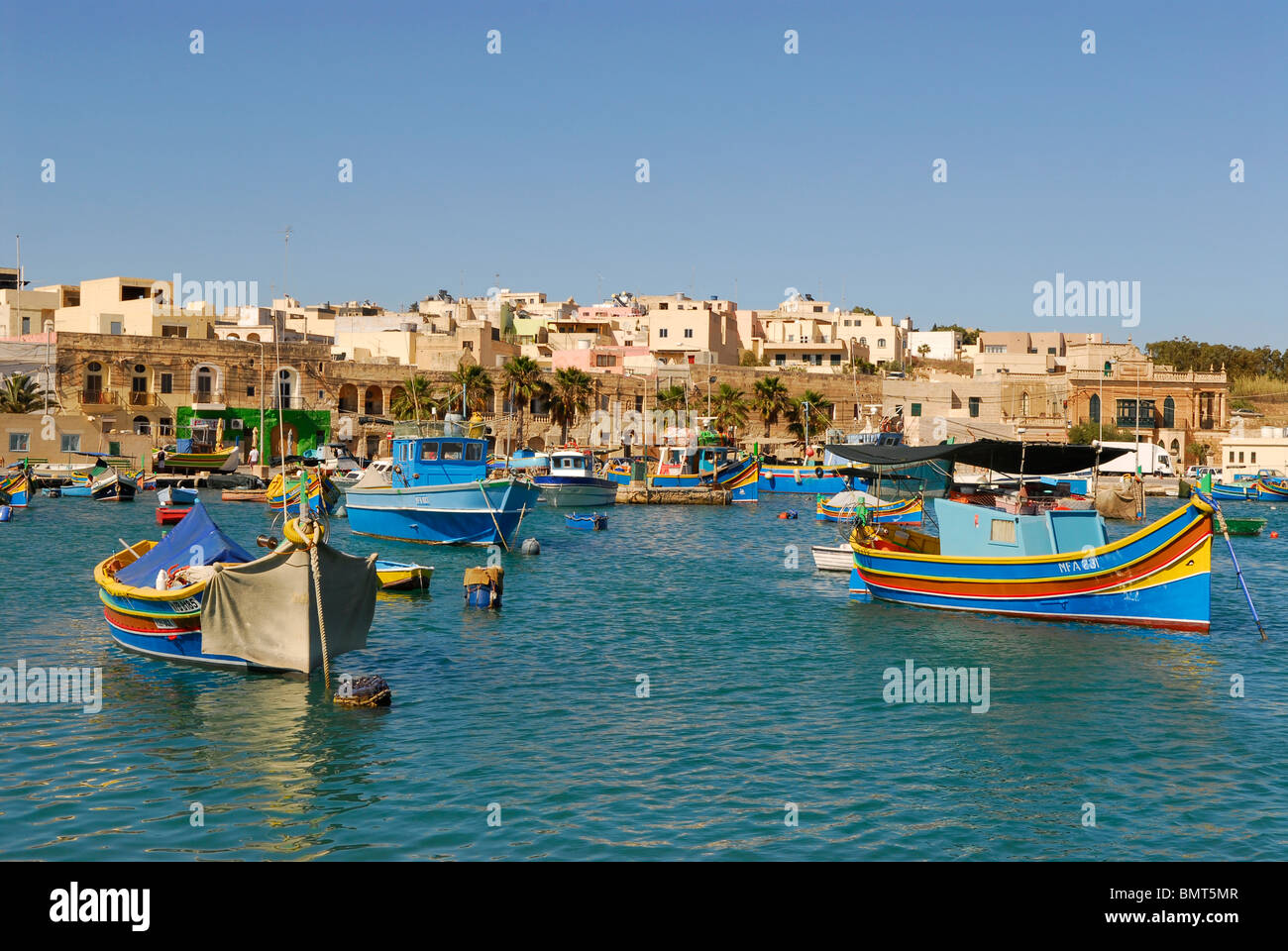 Traditional Maltese fishing vessels moored at the harbour in Marsaxlokk ...