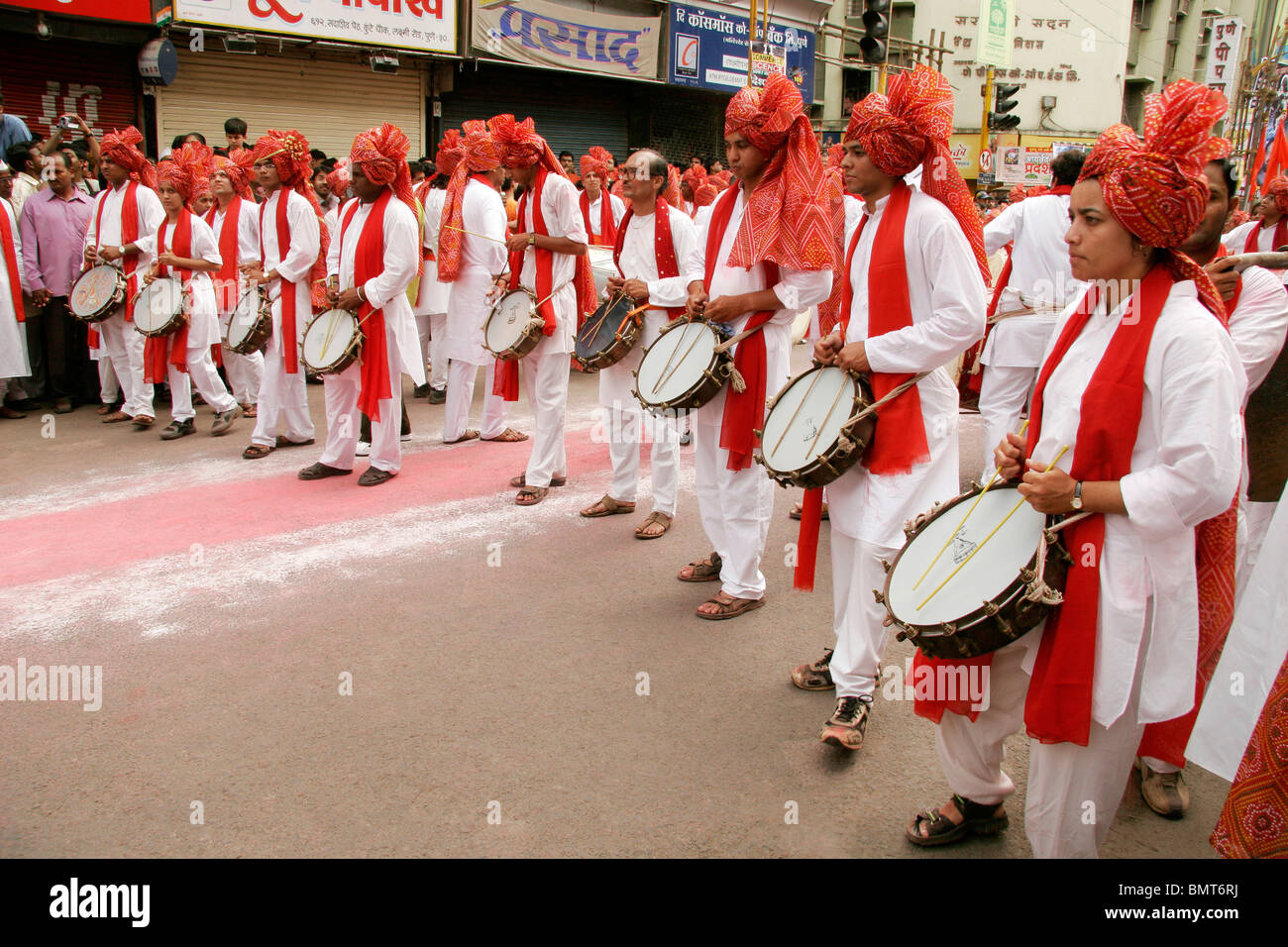 Indian men and women playing Indian musical instrument known 'tasha ...