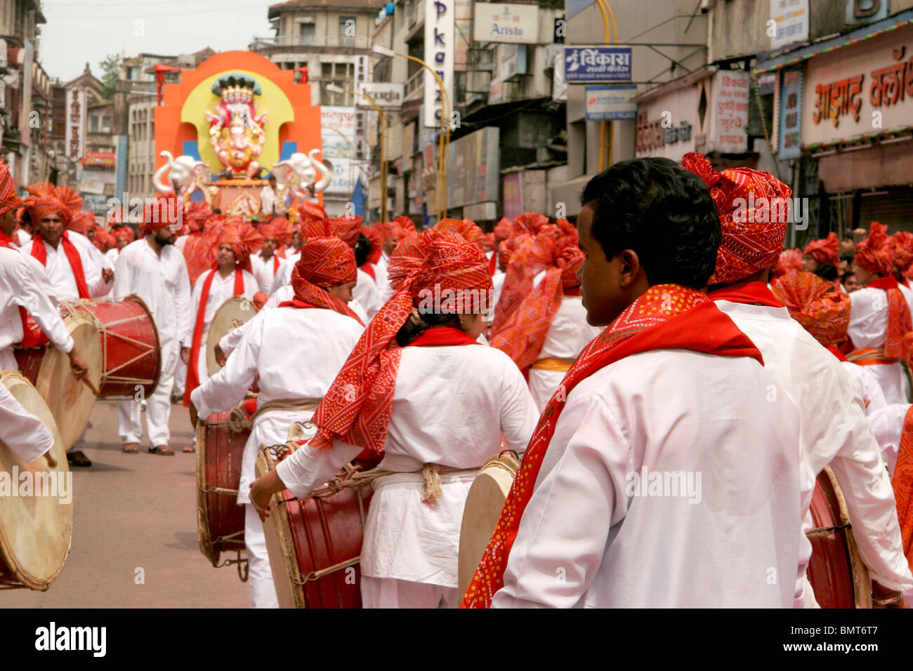 Indian girls and men playing musical instrument called 'dhol' during ...