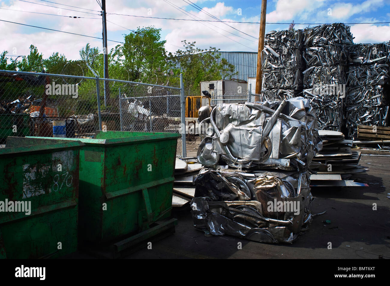 Scrap aluminum is crushed and baled, ready for transport with smaller ...