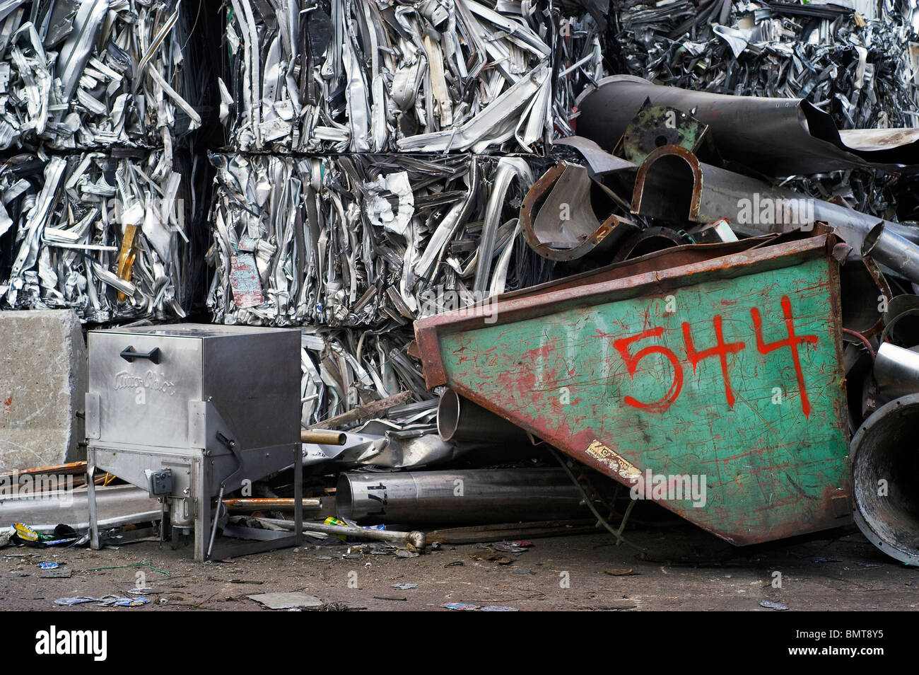 Scrap aluminum is crushed and baled, ready for transport with various ...