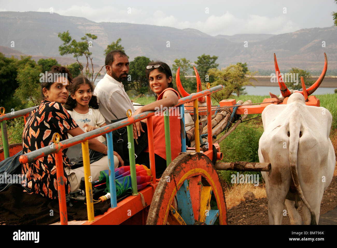 Mother and daughters enjoying bullock cart ride ; Wai ; Maharashtra ...