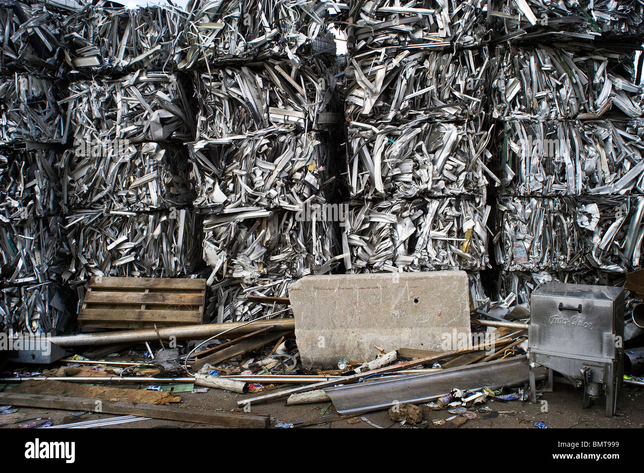 Scrap aluminum is crushed and baled, piled high and ready for transport ...