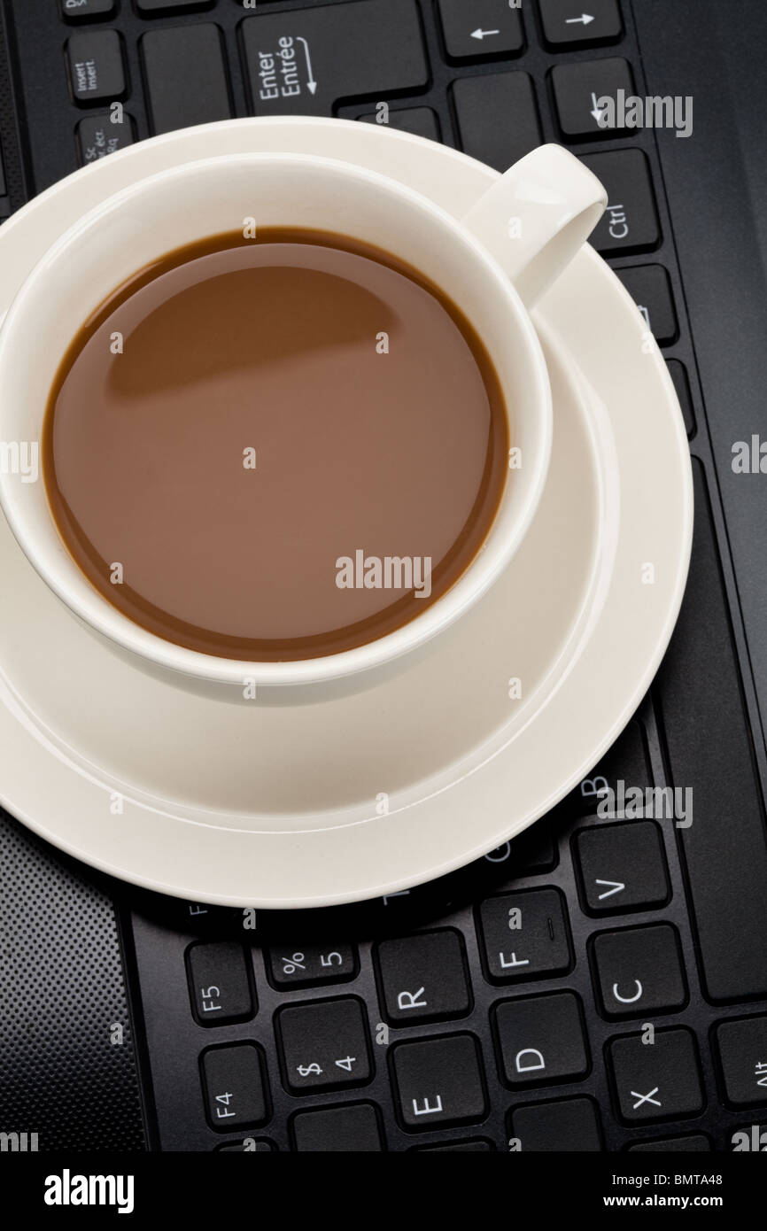 Coffee cup and computer close up Stock Photo - Alamy