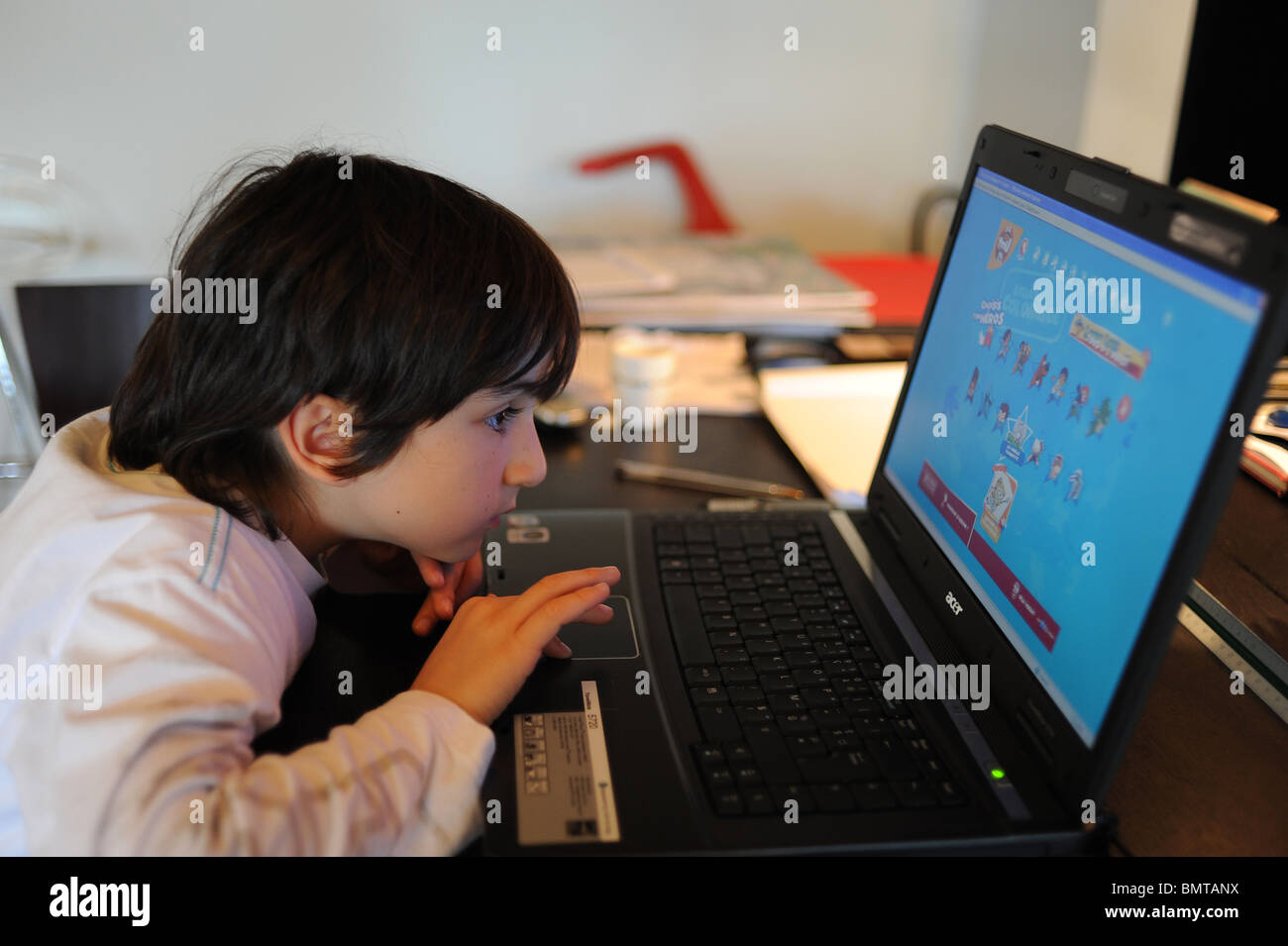 Eight year old boy playing games on the computer Stock Photo - Alamy