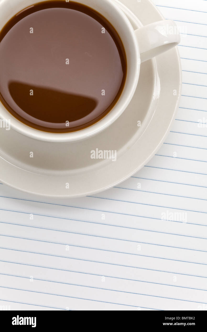 Coffee cup and note pad close up Stock Photo - Alamy