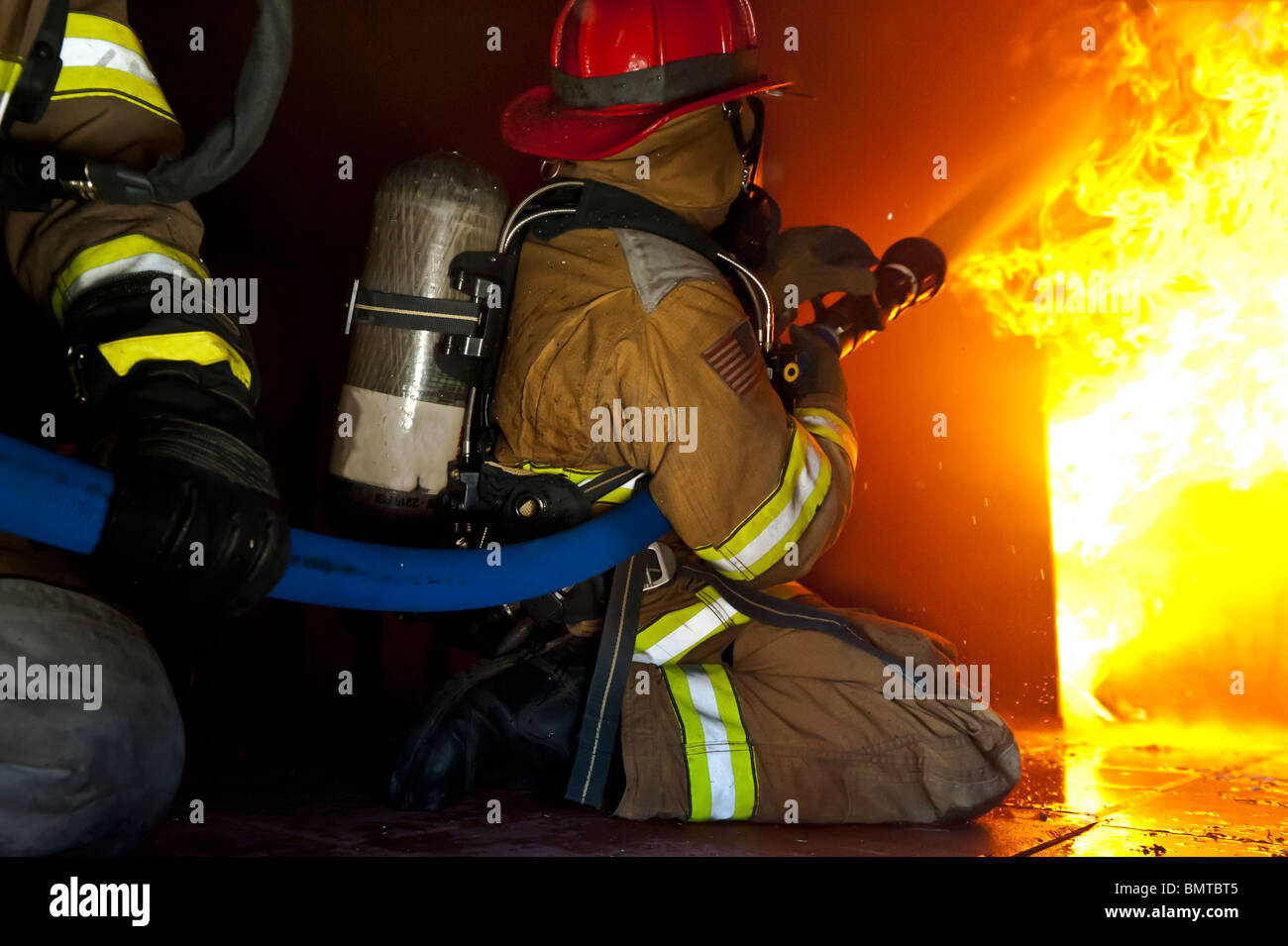 Firefighters attack a fire in a training prop Stock Photo - Alamy
