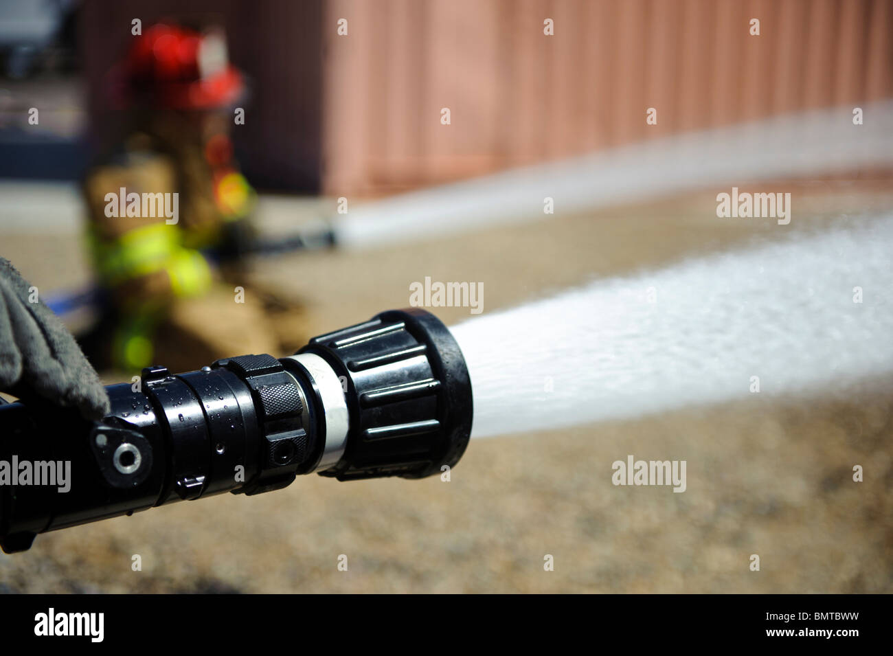 Firefighters spray water during a training exercise Stock Photo - Alamy