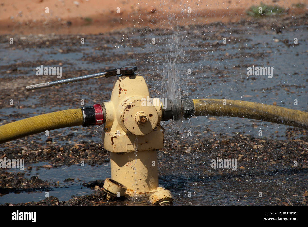 Water leaks from a hose connected to a fire hydrant during a fire ...