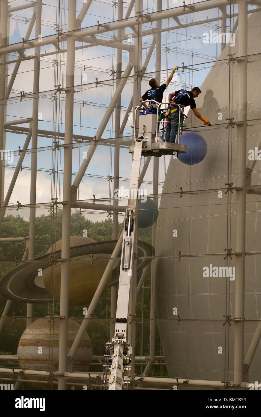 Window washers clean the massive glass curtain wall at the Rose Center ...