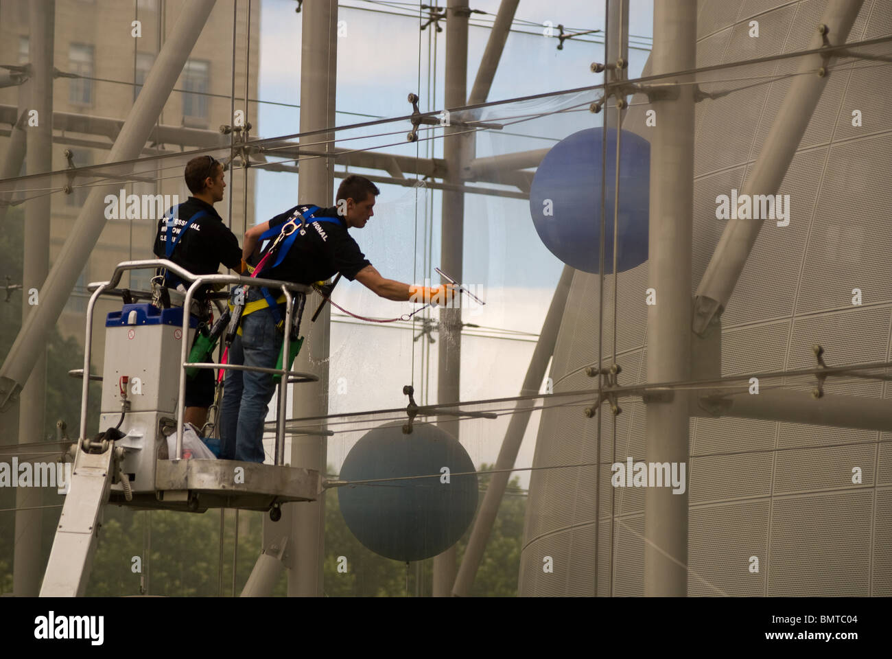 Window washers clean the massive glass curtain wall at the Rose Center ...