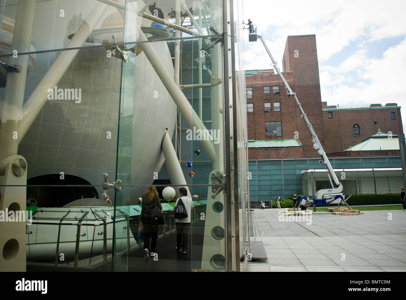 Window washers clean the massive glass curtain wall at the Rose Center ...
