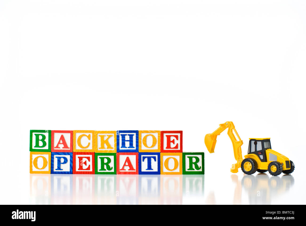 Colorful children's blocks spelling BACKHOE OPERATOR with a model ...