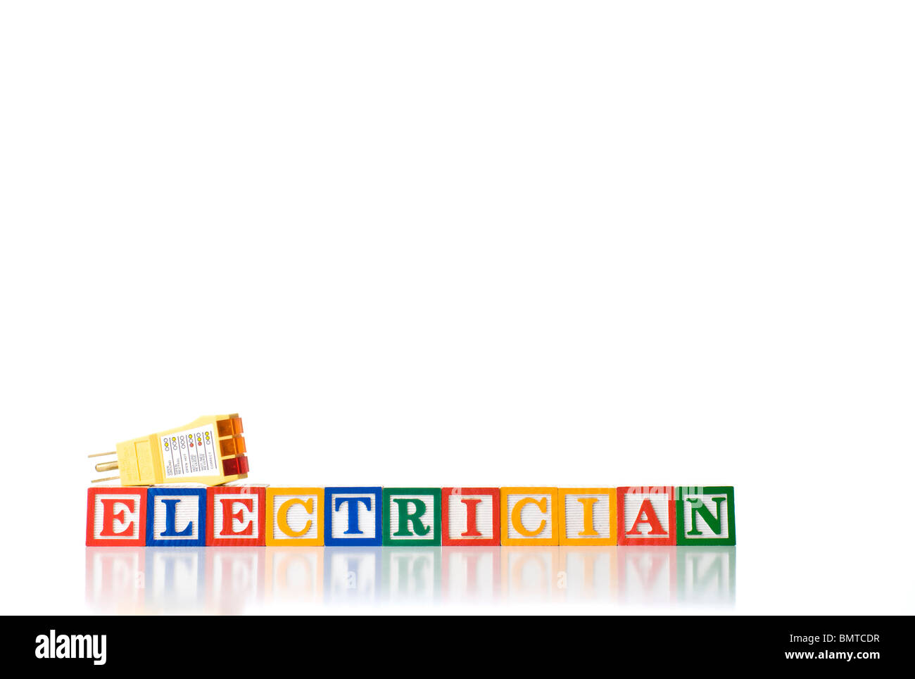 Colorful children's blocks spelling ELECTRICIAN with an outlet tester ...