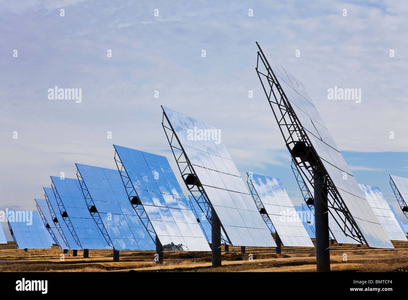 A field of solar mirror panels harnessing the sun's rays to provide ...
