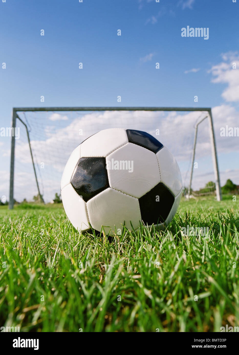 Football in the goal net against blue sky Stock Photo - Alamy