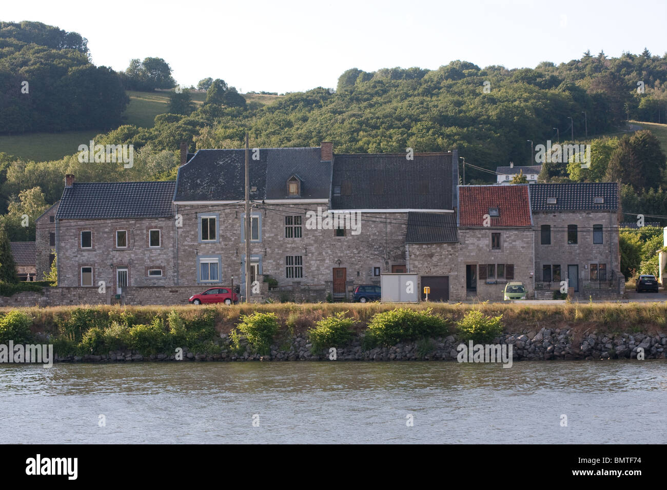 riverside village homes forest river trees hills Stock Photo - Alamy