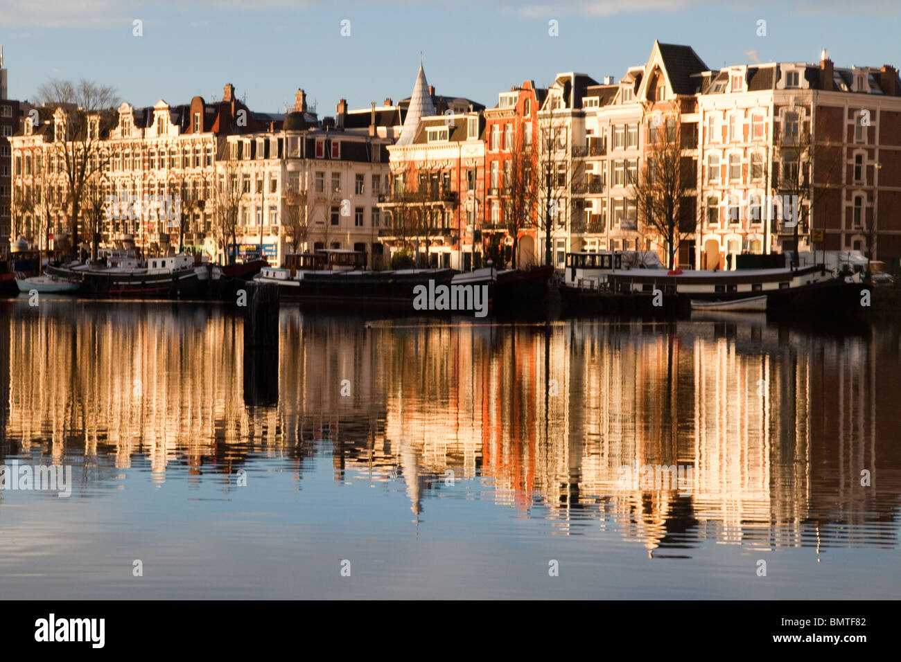 Houses along the river Amstel in the city of Amsterdam, the Netherlands ...