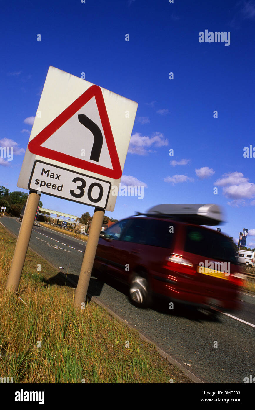 lorry passing warning sign of 30 mph speed limit and sharp left hand ...
