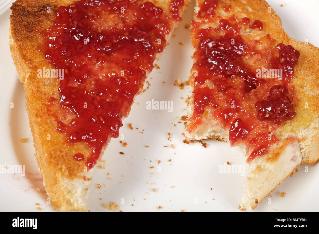 buttered toast and raspberry jam Stock Photo - Alamy