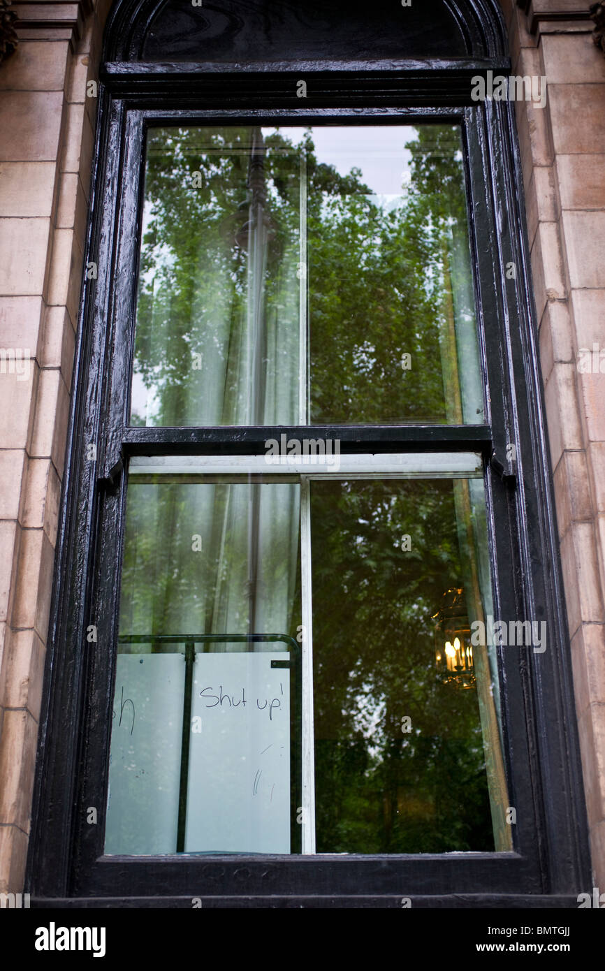 Window with Shut Up sign Stock Photo - Alamy