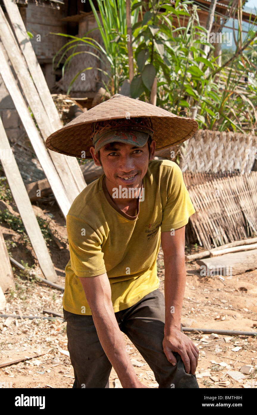 A Lao man sawing wood in a tribal village in Vong Xai province Northern ...