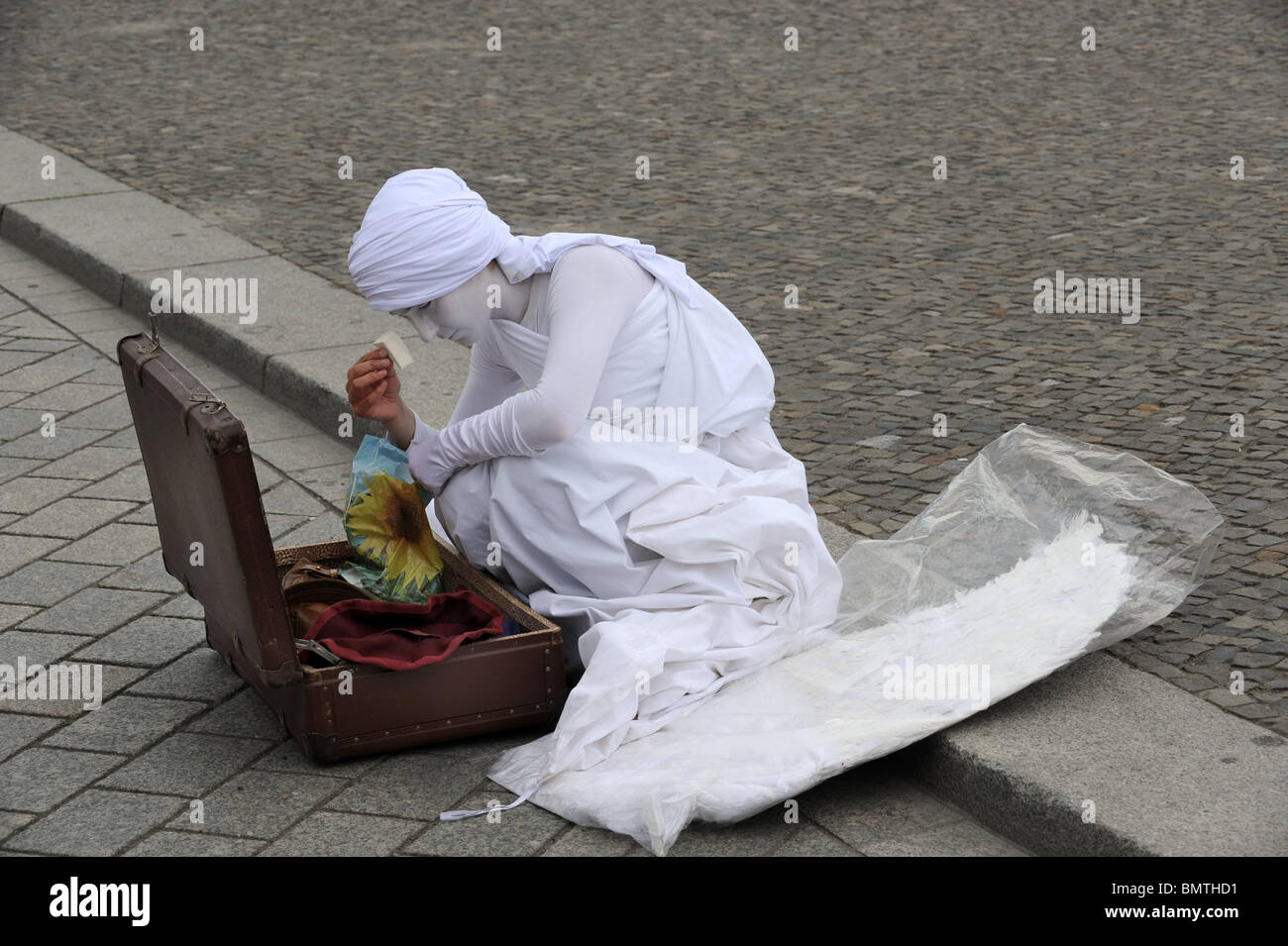 Mime artist preparing for work at The Brandenburg Gate Berlin Germany ...