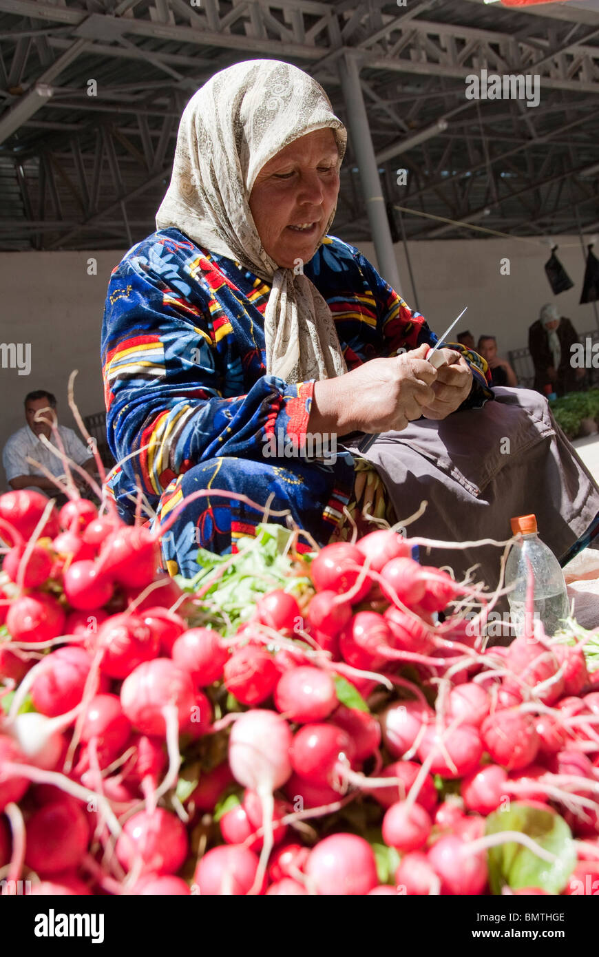 Woman selling radish in a Fresh fruit and Vegetables market in Fergana ...