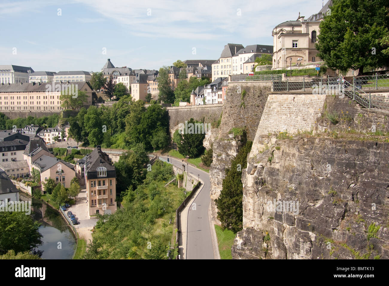 cliff river valley trees homes buttress defenses Stock Photo - Alamy