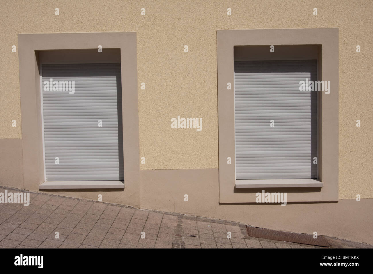 terraced houses blinds windows steep hill peach Stock Photo - Alamy
