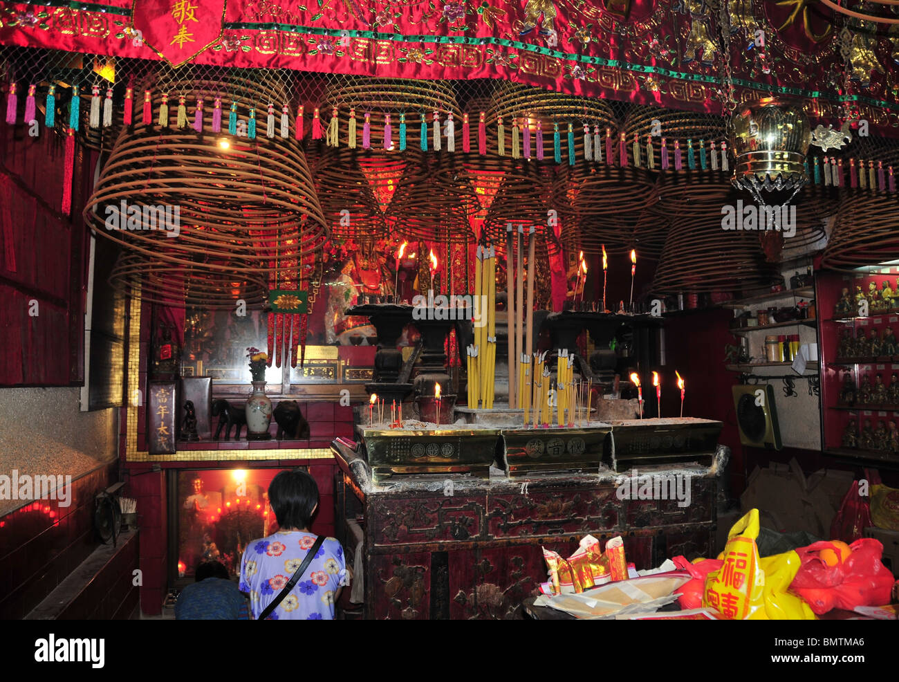Incense cone, joss-stick, gold statue interior of the Kwun Yam Temple ...