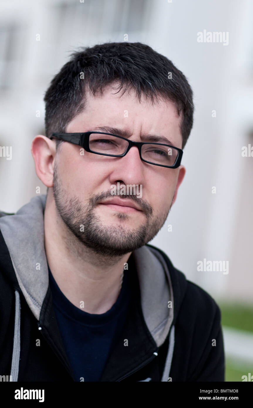 Portrait of a young male caucasian student with beard and glasses Stock ...