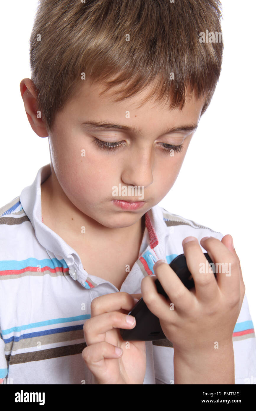 Small boy using a telephone talking to his friend Stock Photo - Alamy